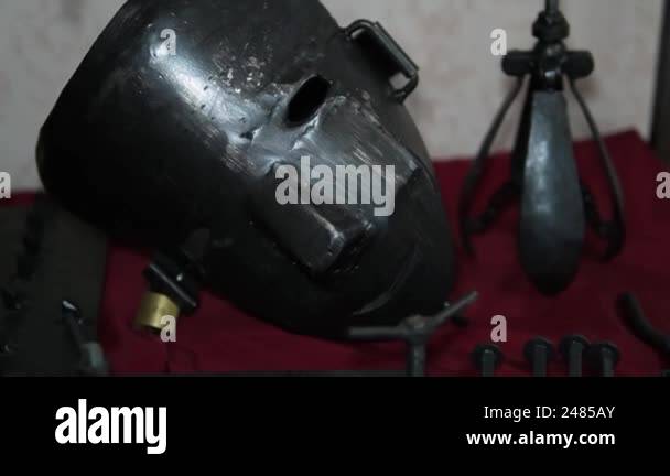 An iron mask, a torture method used in ancient times. Nearby are metal ...