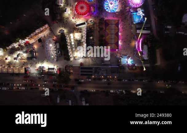 Carnival rides, bright lights, and fun had by all. An aerial view of a ...