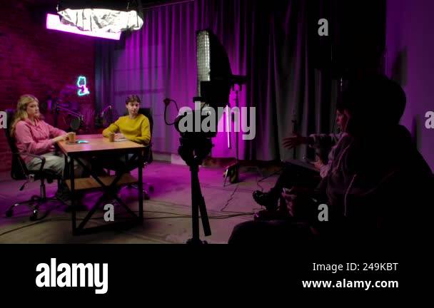 Online podcast. Backstage shot of interview in loft podcast studio, man ...