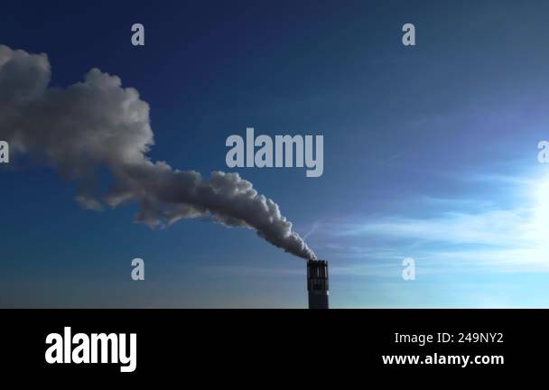 industrial chimneys emitting white smoke over city skyline under blue ...