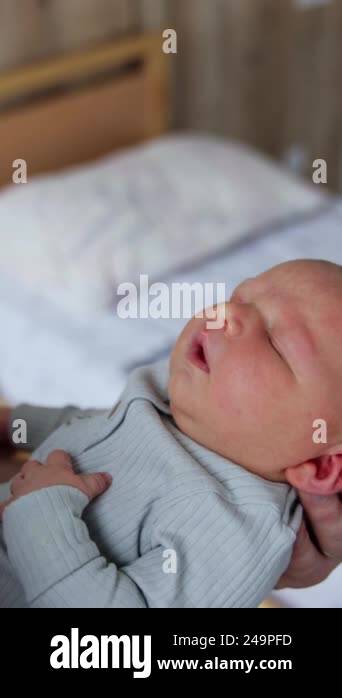Adorable little newborn sleeping peacefully on the dad's hand. Father ...