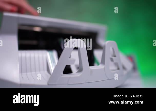 Starting a cash counting machine. Blades of device rotate and new one ...