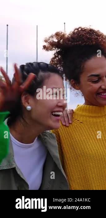 Vertical HD video of young diverse group of happy girls laughing ...