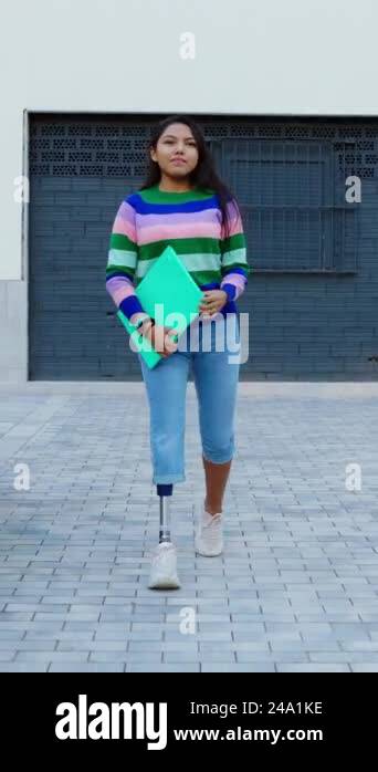 Vertical HD video of young student woman with prosthetic leg meeting ...