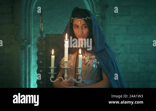 Beautiful young mysterious fairytale woman in halloween costume medieval queen posing model on ...