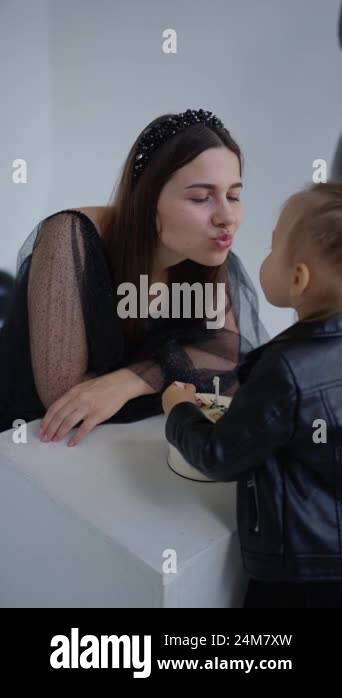 Sincere expression of maternal love, when woman in shiny black dress ...
