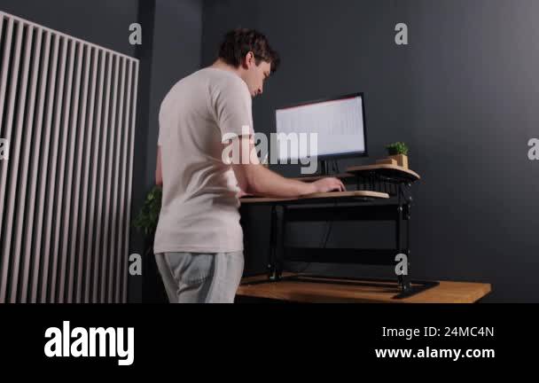 Inputting text, man typing, desk computer. Viewed from back, man in ...