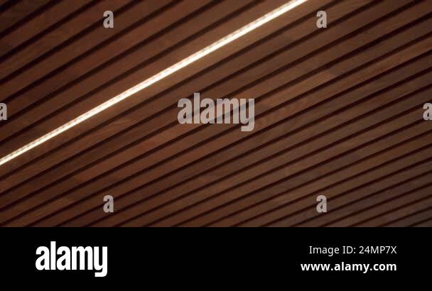 Close-up of wooden slats with a sleek linear light creating a modern ...
