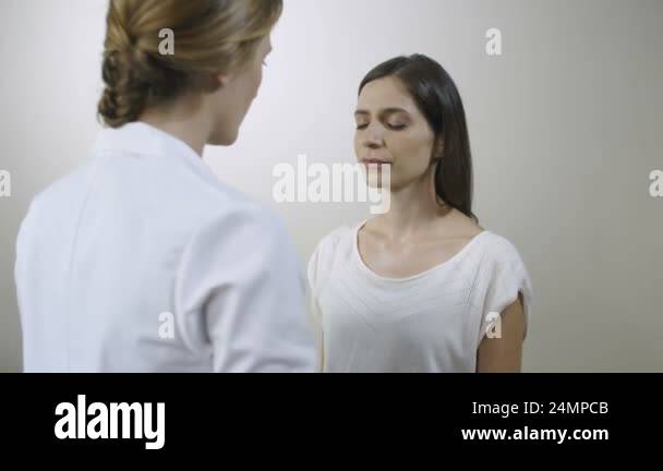 Neurologist performing the Romberg's test on a female patient to test ...