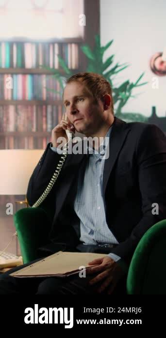 Vertical Video Intelligence officer on a secure line answering phone ...