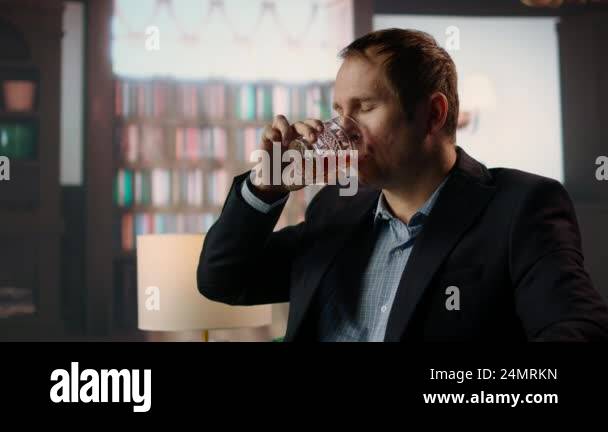 Old money classy heir drinking a glass of whiskey at elite social club ...