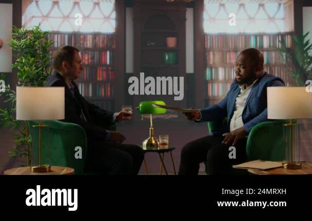 Team of intelligence agents reviewing critical documents in a vintage ...