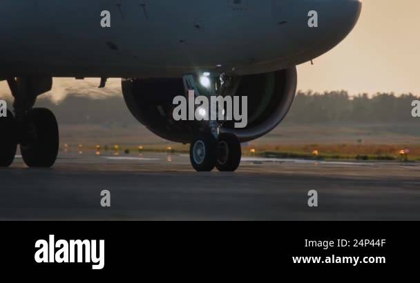 Detailed View of Aircraft Wheels and Engine on Runway at Sunset ...