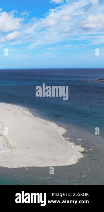 Ocean view featuring a white sandbar. The water displays varying shades ...