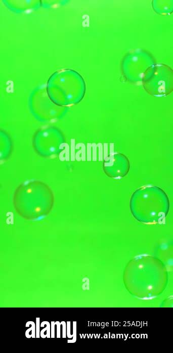 Super slow motion of flying soap bubbles on green screen background ...