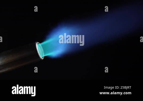 Close up of intense jet flame coming out of a burner pipe on black ...