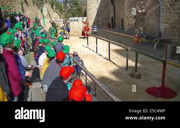 Actor dressed as medieval clown entertains spectators between ...