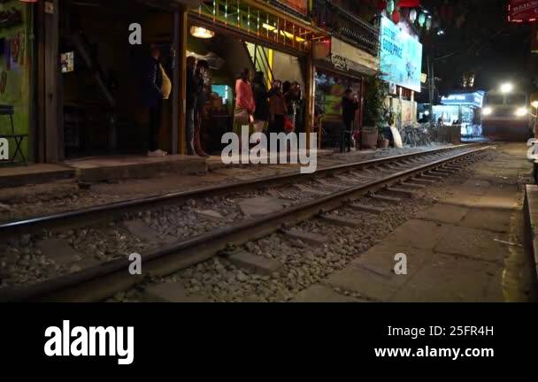 A locomotive pulls into the train street of the Old Quarter, where many bars with visitors are ...