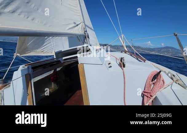 Sail boat full wind towards the sun in open sea. High quality FullHD ...