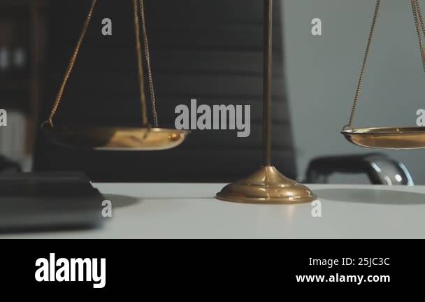 golden scales on wooden table. law concept Stock Video Footage - Alamy