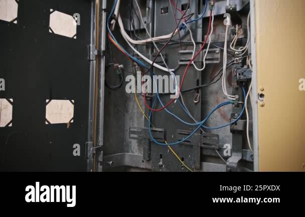 A close up shot of a partially exposed metal electrical panel box ...