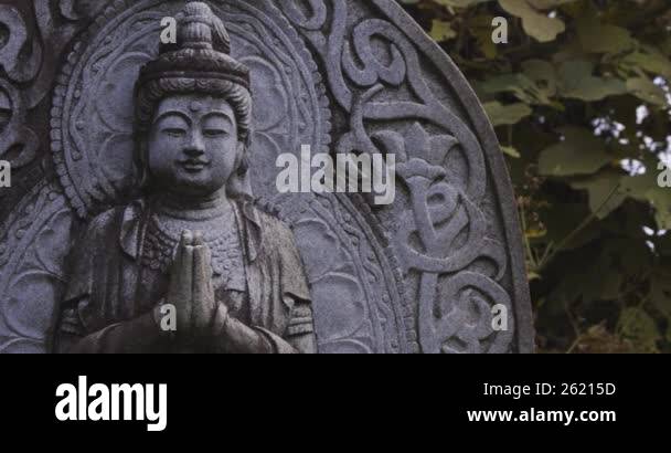 A buddhism stone statue at Japanese temple. High quality 4k footage ...