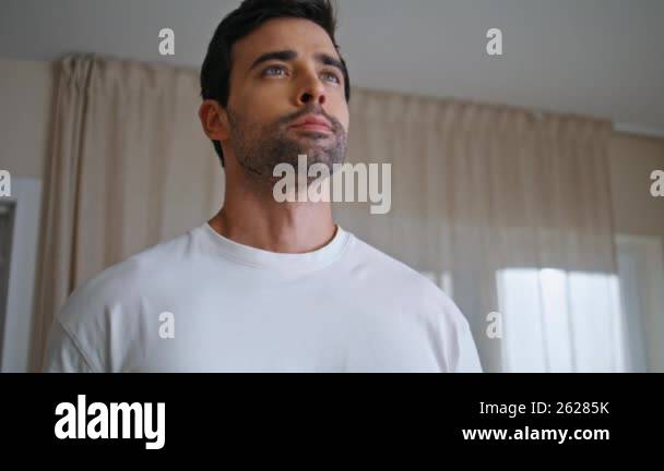 Hispanic man training arms muscles in apartment closeup. Focused young ...