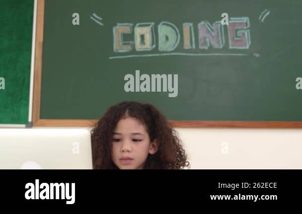 Attractive african student programing system while looking at camera ...