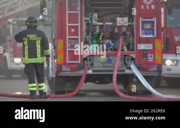 Rovigo, Italy 1 January 2025: Firefighters managing equipment, preparing hoses from a fire truck ...