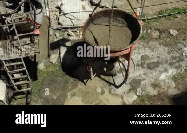 Above view, tower crane as raising upward cone tank, conical metal ...