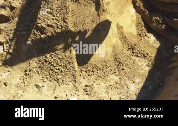 Above view on excavator's work tool, blade as digging, excavating foundation for new residential ...