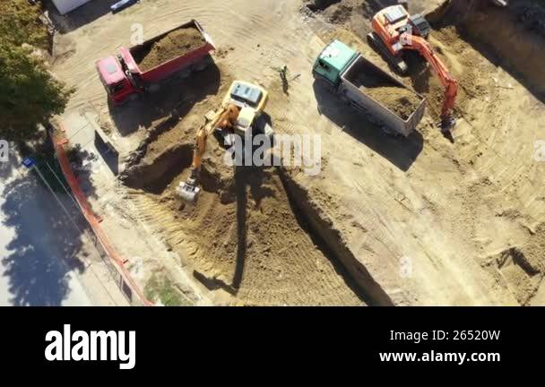 Above top dolly move view on two big excavators as they digging, excavating foundation for new ...