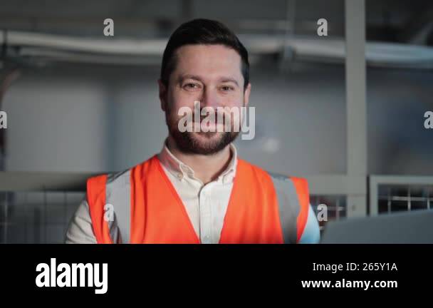 Confident electrical engineer working with laptop near electrical ...