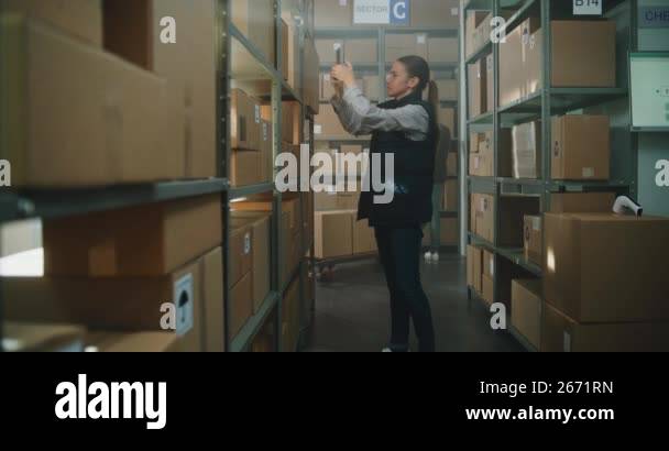 Female Sorting Center Employee Scans Parcels with Online Orders Using Smartphone, Checks ...