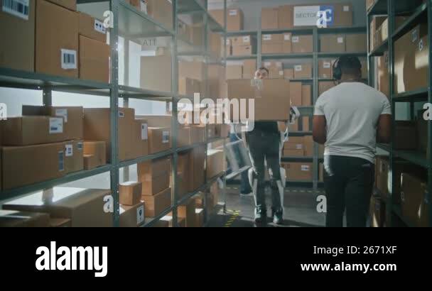 High-Tech Advanced Warehouse: Sorting Center Worker Wearing Futuristic ...