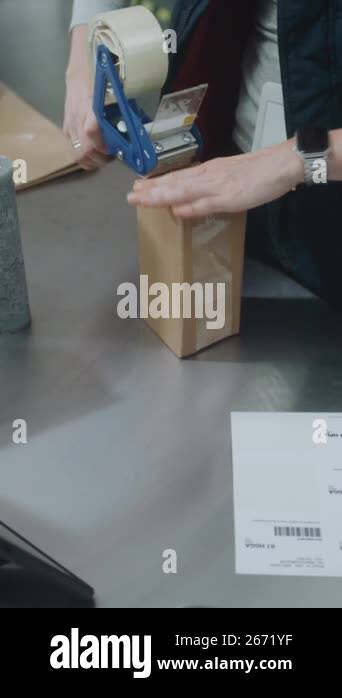 Warehouse Clerk Packs Cardboard Box with Online Order, Scans Code, Uses ...