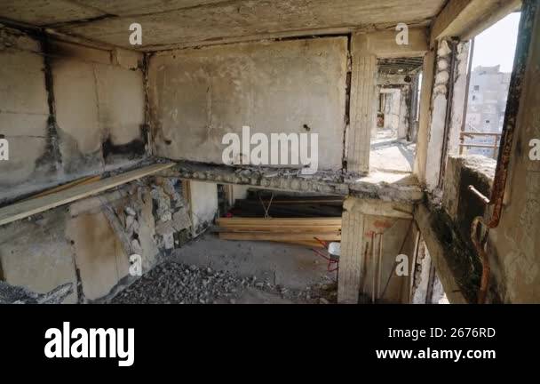 Damaged interior, collapsed ceilings in deserted building. Burnt ...