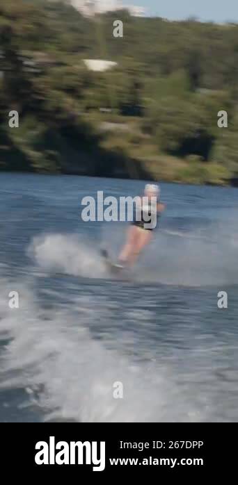 Female athlete gliding dynamically across sparkling lake surface, water ...