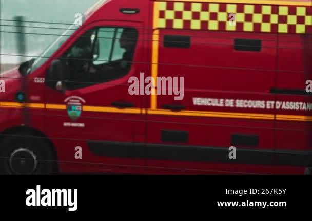 View from a moving train of a red ambulance on the streets of Nice ...