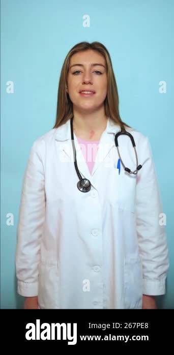 vertical Confident female medical professional in white lab coat and ...