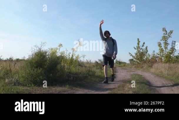 Happy Caucasian Man Waves Hand Greeting Gesture While Walking. Slow ...