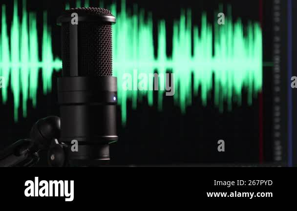 slow focus shift from microphone to audio waveform on screen ...