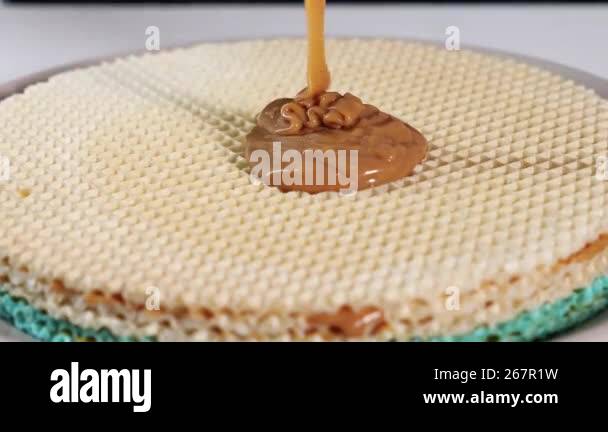 zoomed-in view of caramelized condensed milk dripping onto waffle ...