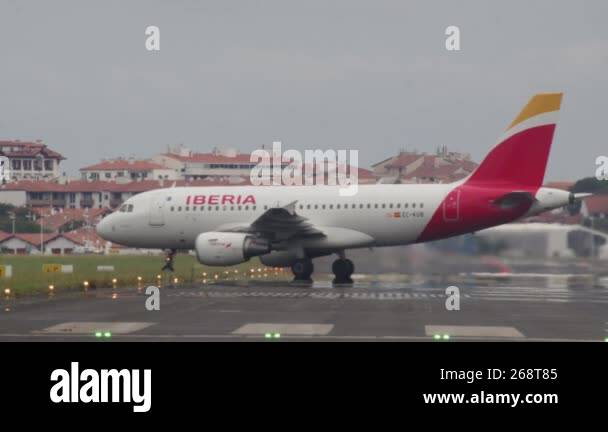 SAN SEBASTIAN, SPAIN, JULY 31, 2024: Iberia Airbus A320 gathering speed while accelerating ...