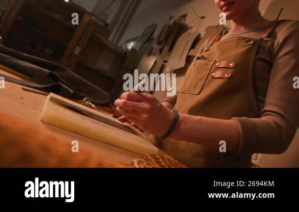 Low angle shot of leather punching process made by professional ...