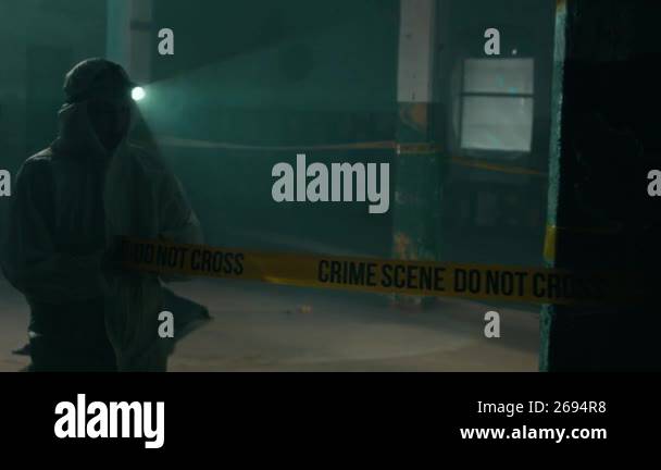 Tracking lowkey shot of female forensic expert wearing protective suit ...