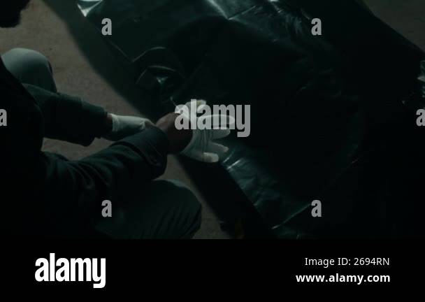 High angle cropped shot of Black male forensic expert putting on ...