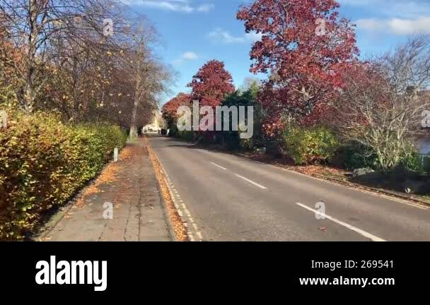 A tree lined road with autumn rustic colours in Inverness, Scotland ...
