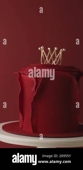 Vertical footage of rotating birthday cake in the shape of the red rose ...