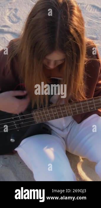 Girl playing bass guitar in the nature near the beach Stock Video ...